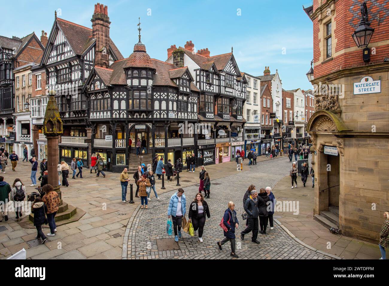 Shoppers walking over wet pavements and cobbles in the Roman town of ...