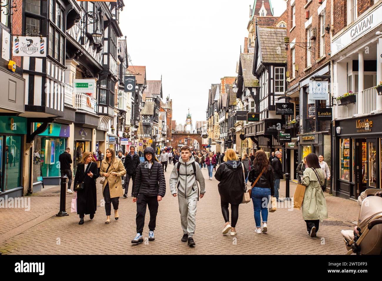 Shoppers walking over wet pavements and cobbles in the Roman town of ...