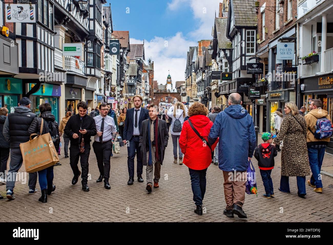 Shoppers in the Roman town of Chester England around the medieval cross ...