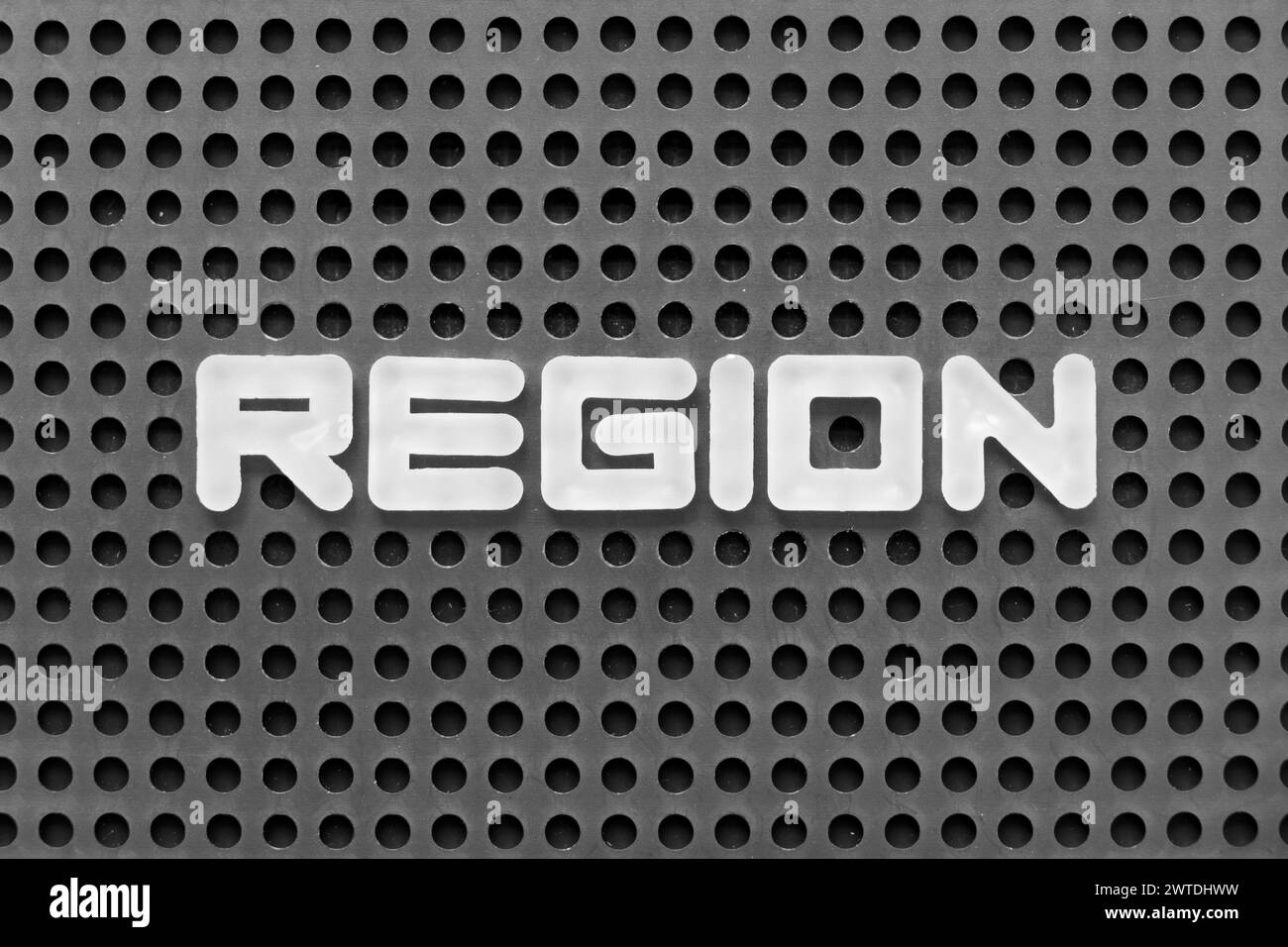 White alphabet letter in word region on black pegboard background Stock ...