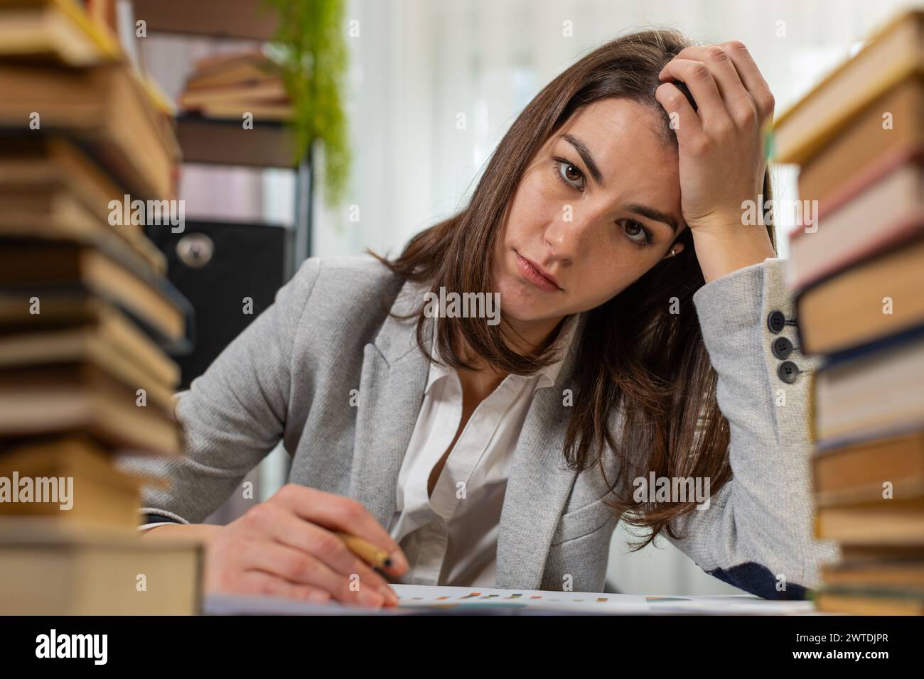 Exhausted Caucasian business woman looking at documents reports while ...
