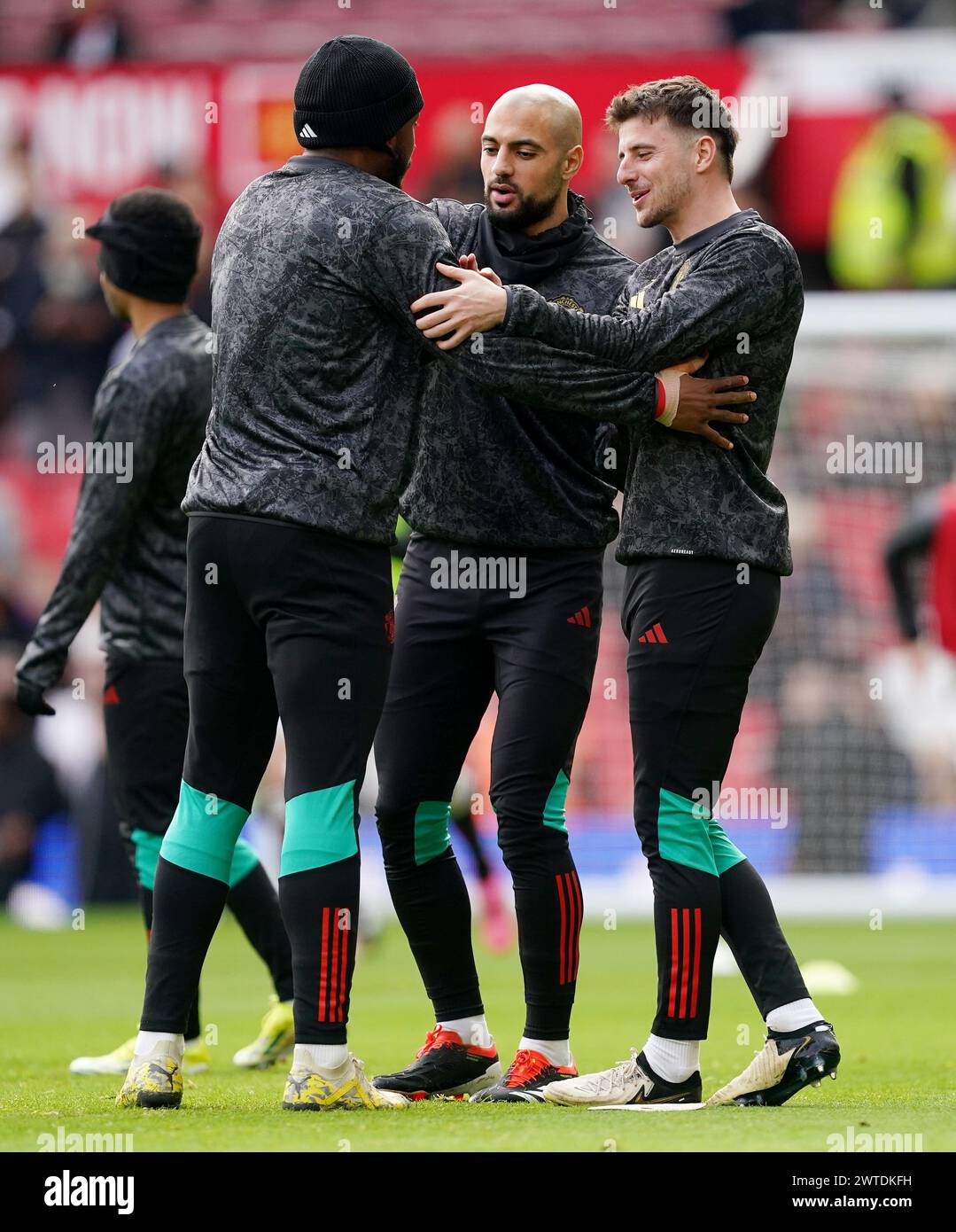 Manchester United's Sofyan Amrabat (centre) and Manchester United's Mason Mount warm up ahead of ...