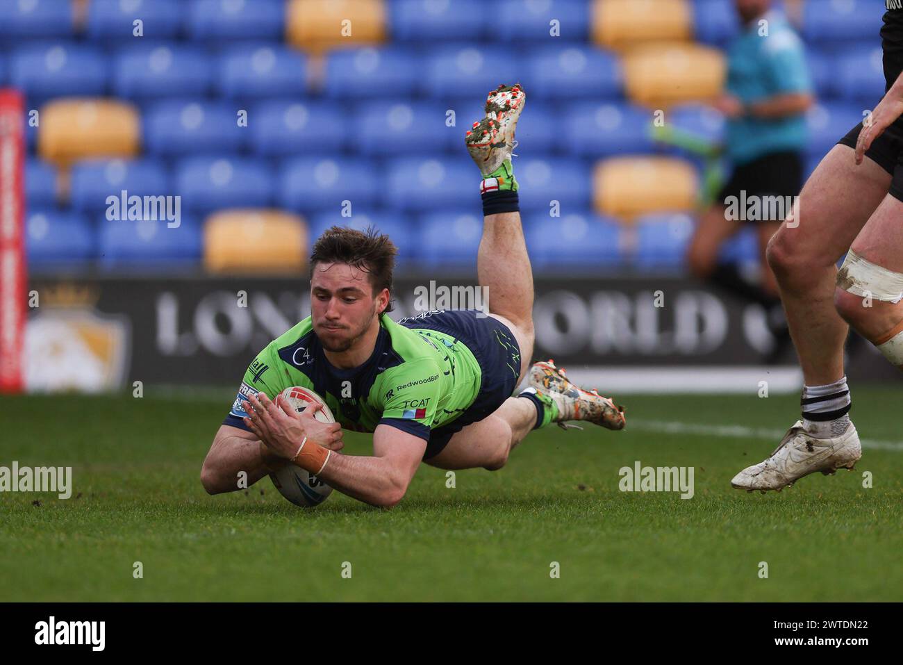 London, UK. 17th Mar, 2024. Adam Holroyd of Warrington Wolves scores a ...
