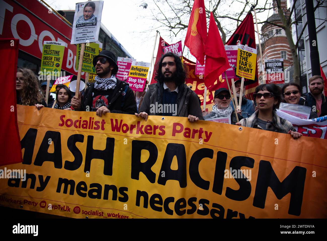 Protestors march with a large banner and placards during the UN Anti ...