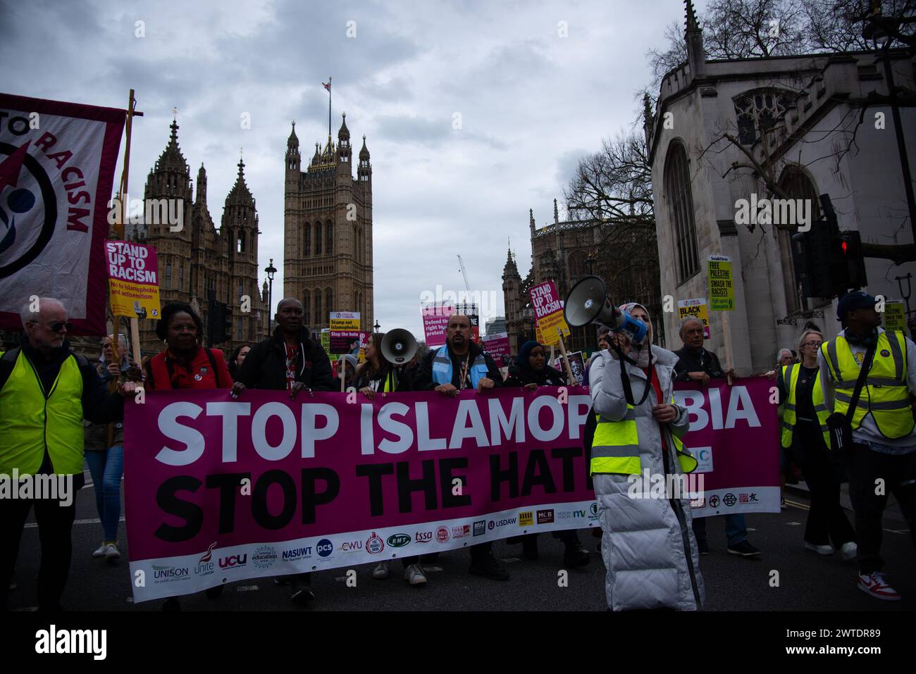 London, UK. 16th Mar, 2024. Protestors march with placards and large ...