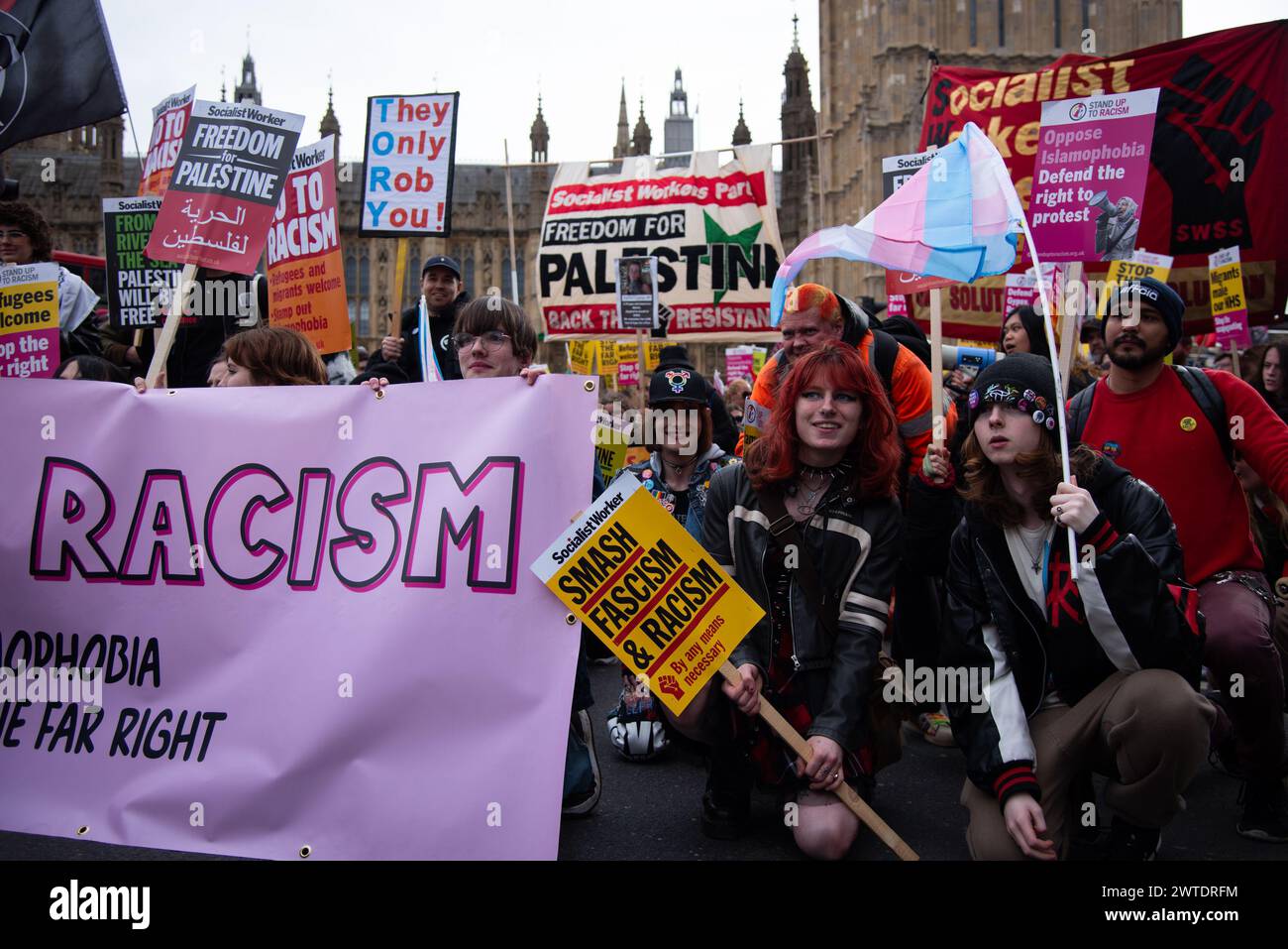 Protestors march with a large banner and placards during the UN Anti ...