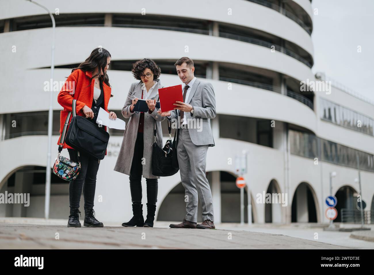 Business colleagues in conversation outside modern building Stock Photo ...