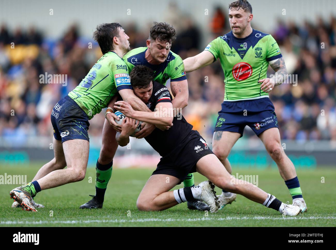 London Broncos' Alex Walker is tackled by Warrington Wolves' Adam ...