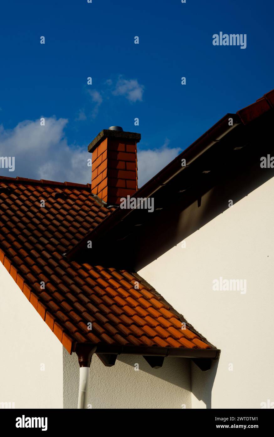 Details of red roofs and a chimney in bright sunlight with formal ...