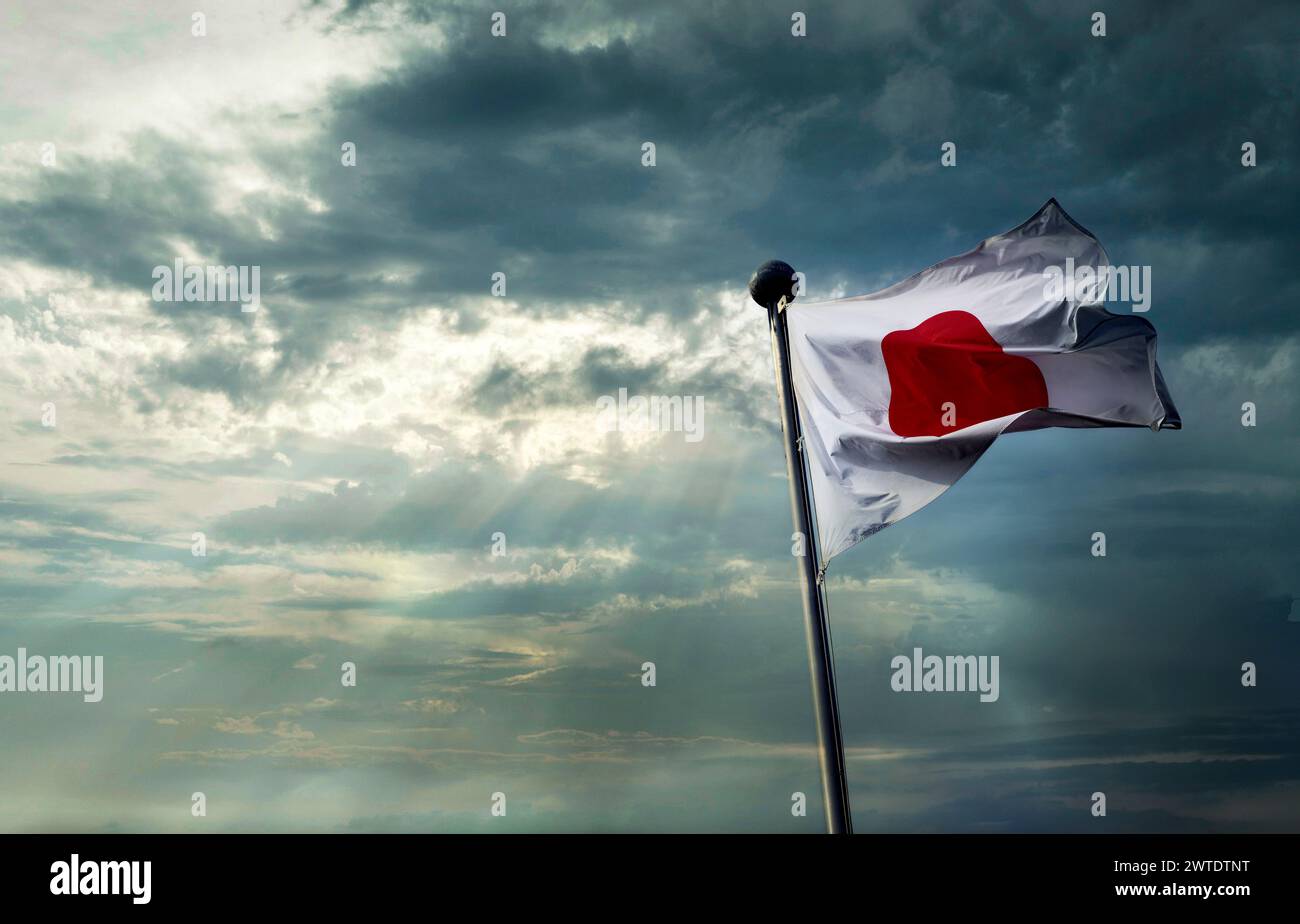 A photograph of a Japanese Rising Sun Flag against a dramatic sky Stock ...