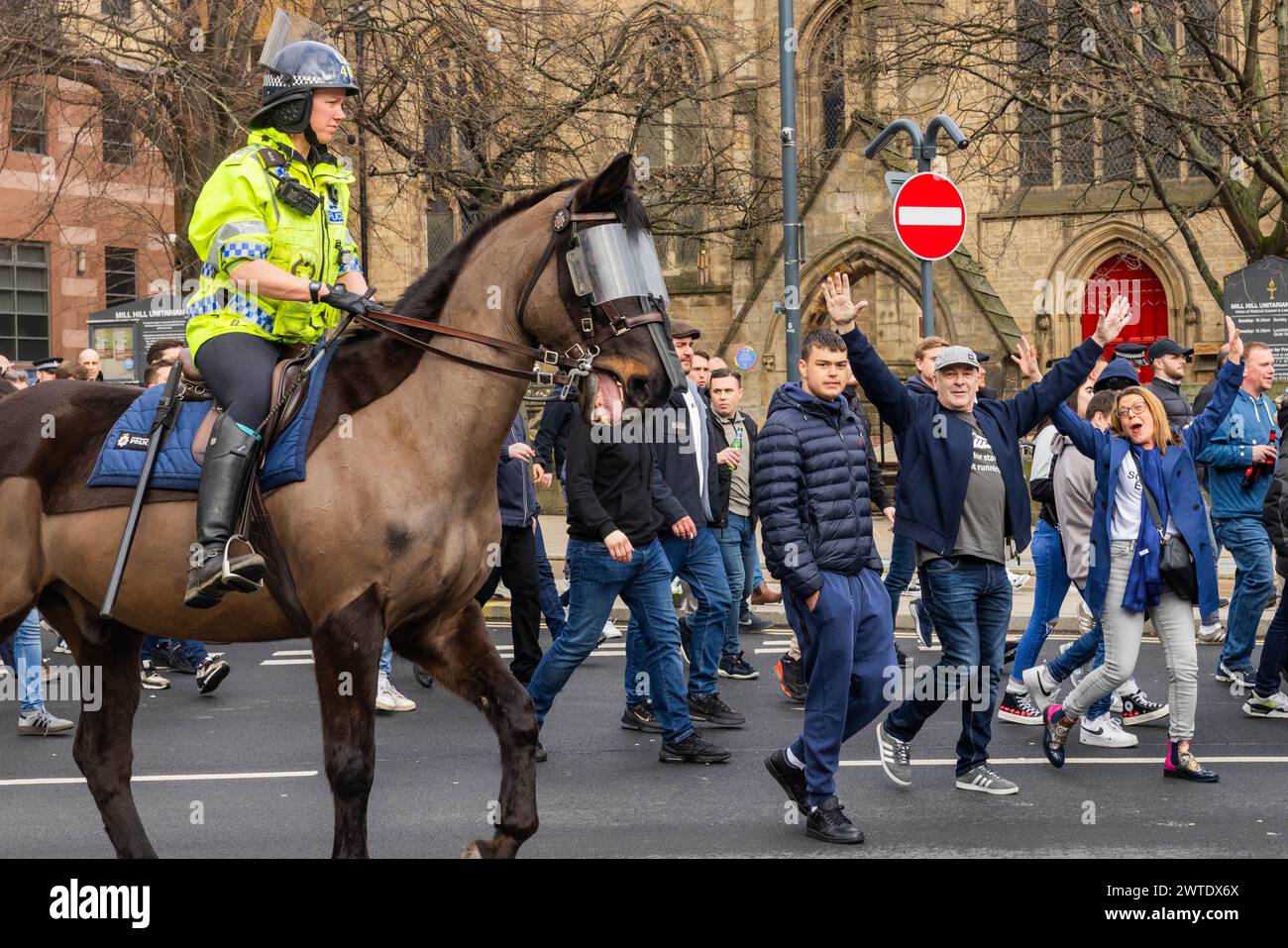 Leeds, UK. 17 MAR, 2024. Millwall fans gesture to camera as they march ...