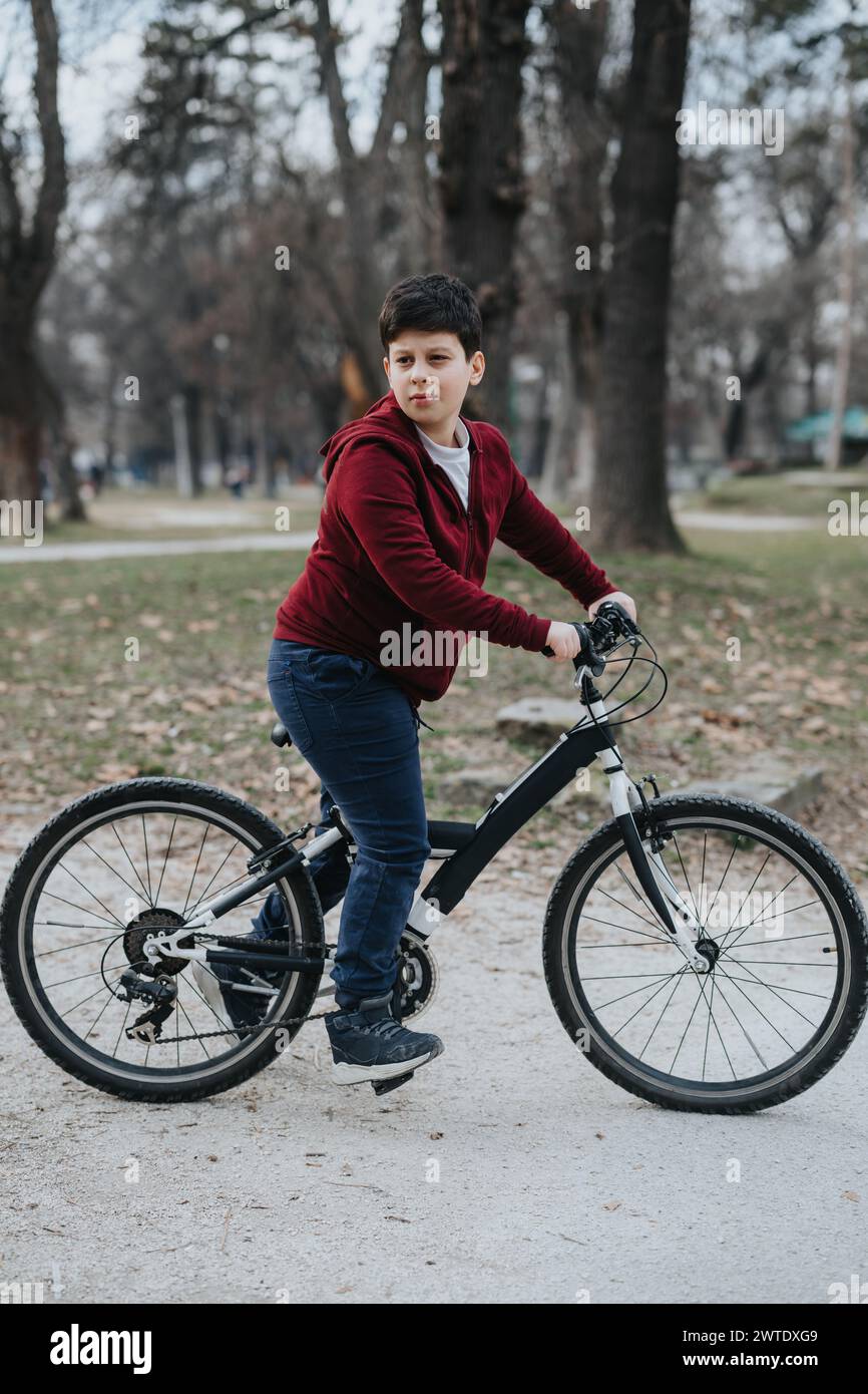 Young boy enjoying a bike ride in the park, joyful and active kid ...
