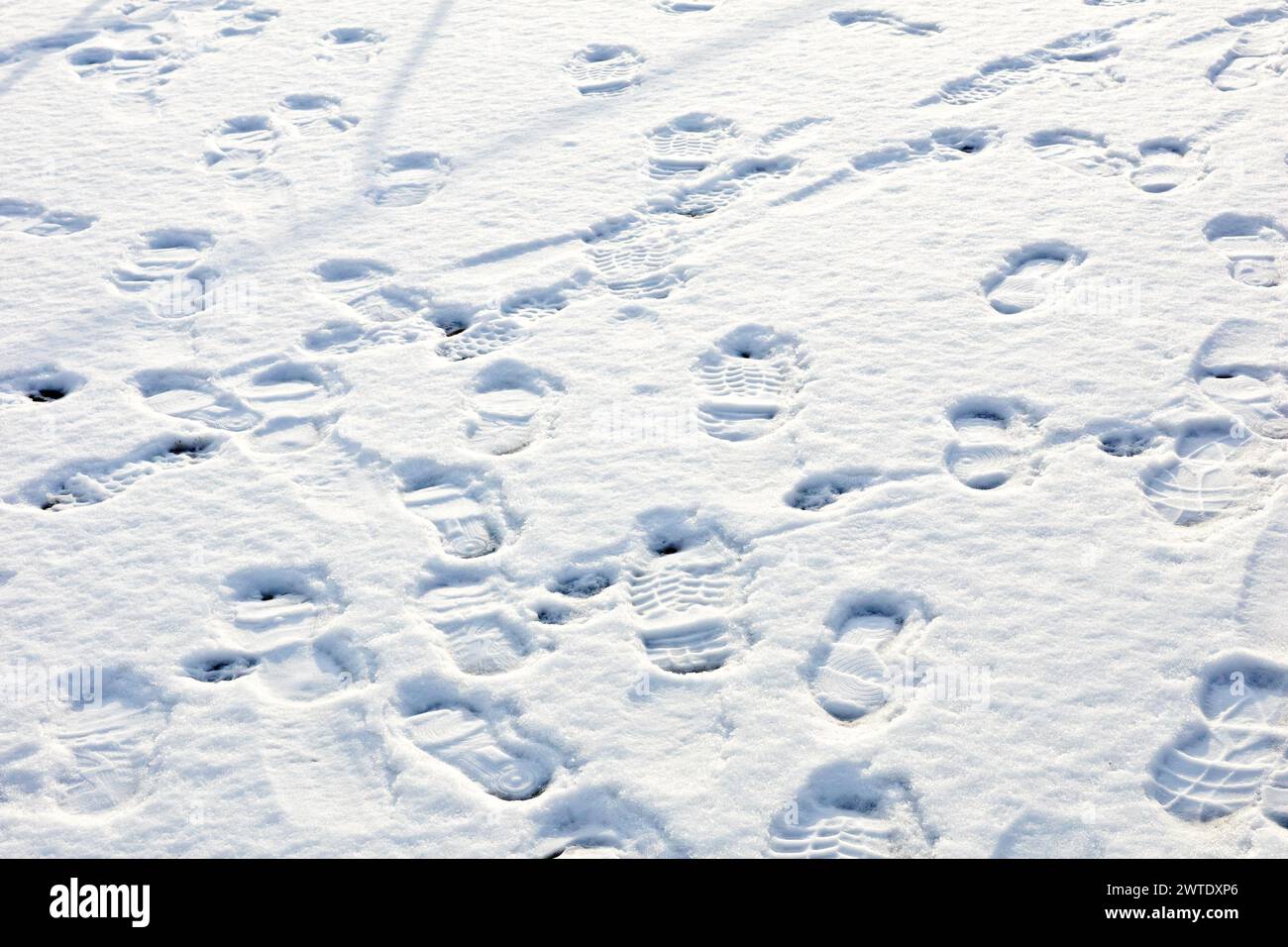 Footprints in the snow, close up of several tracks of bootprints and ...
