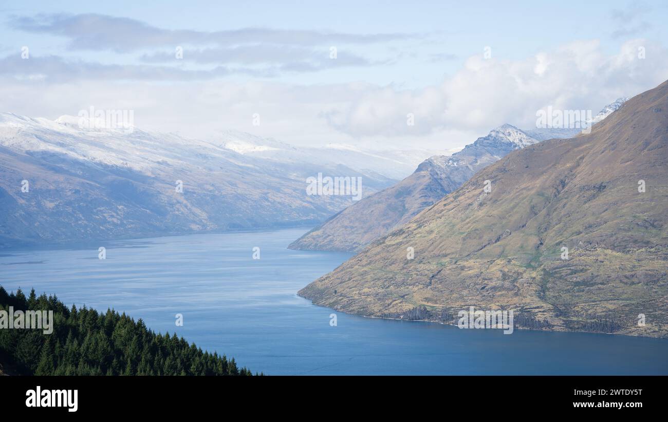 Beautiful alpine landscape with snowy mountains, blue lake and dense ...