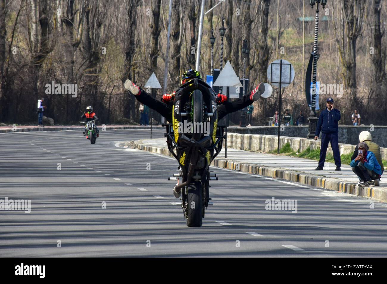 Srinagar, India. 17th Mar, 2024. A professional bike rider performs a stunt during a motorsport ...