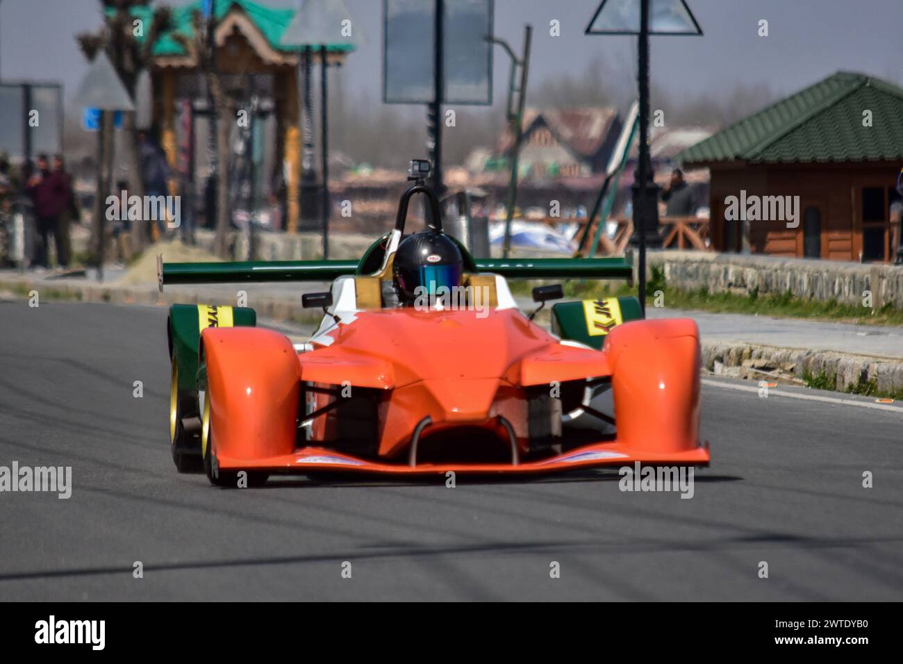 Srinagar, India. 17th Mar, 2024. A racing car moves along the road during a motorsport event ...