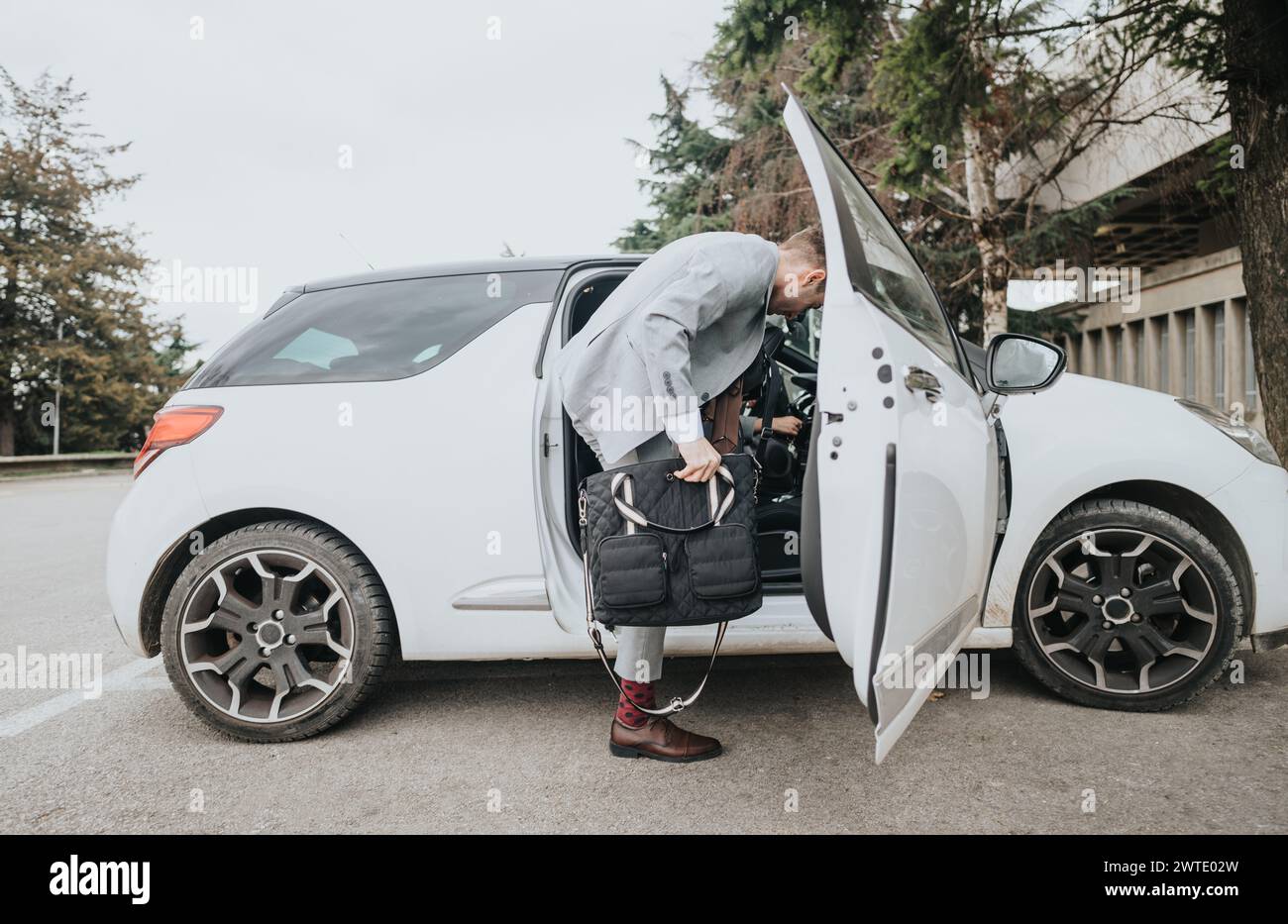 Business professional entering a car, ready for a meeting Stock Photo ...