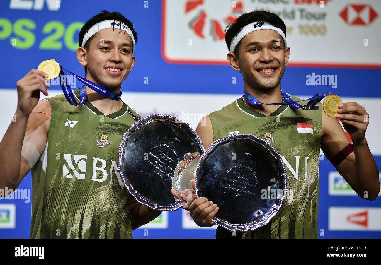 Indonesia's Fajar Alfian, right, and Muhammad Rian Ardianto pose with trophy after winning the ...