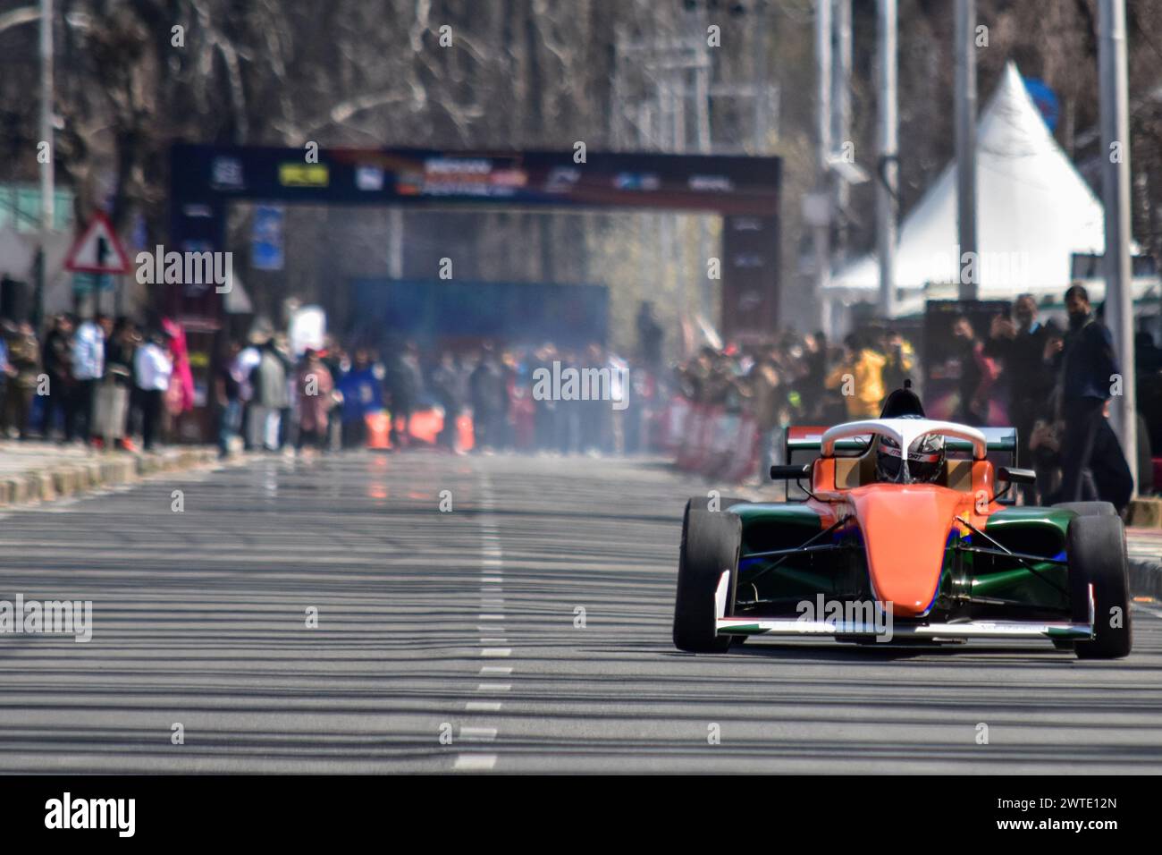 Srinagar, India. 17th Mar, 2024. A racing car moves along the road during a motorsport event ...