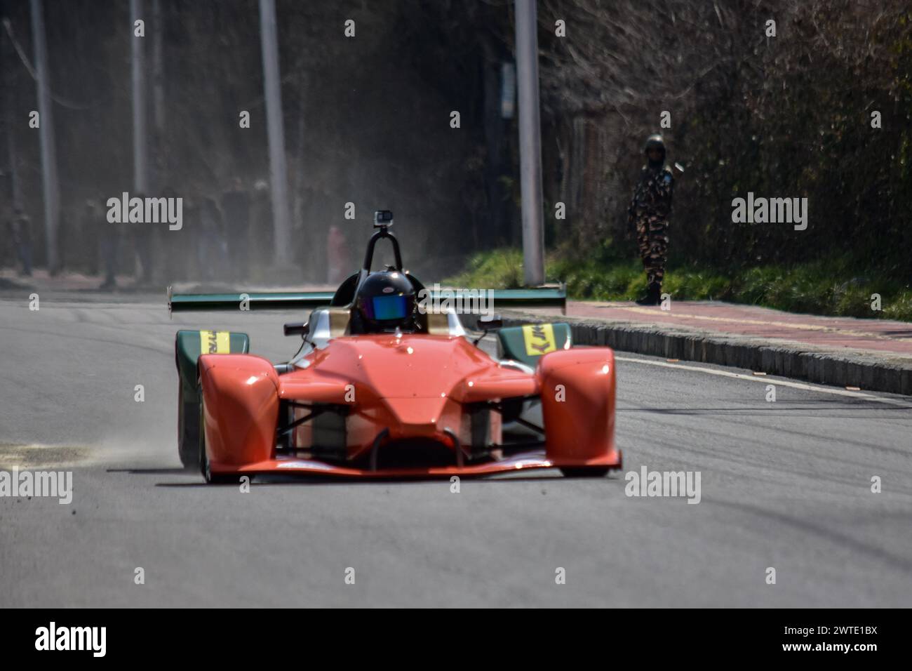 Srinagar, India. 17th Mar, 2024. A racing car moves along the road during a motorsport event ...
