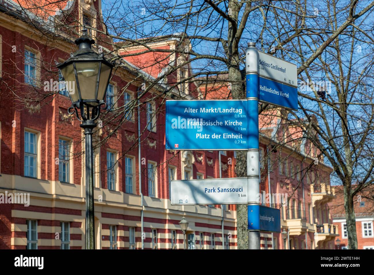 Blue signs show the way to tourist destinations. White signs point the ...