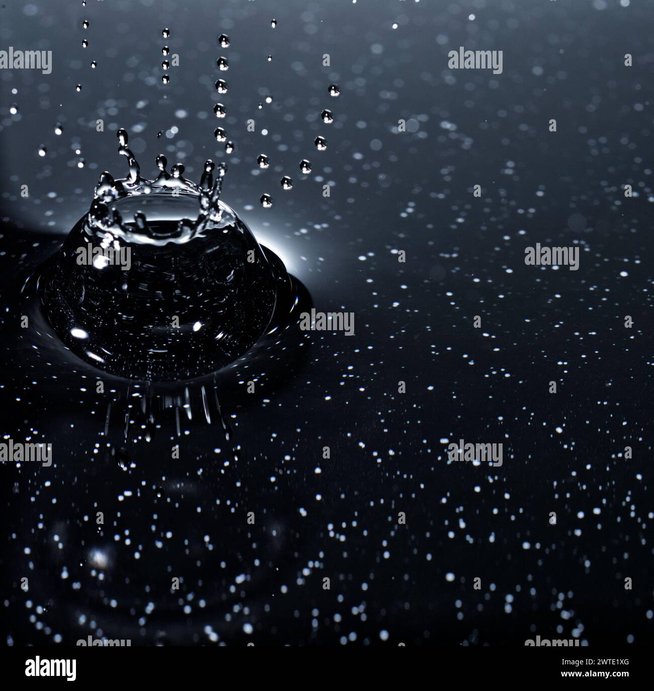 Splash - falling water drops in color macro shot Stock Photo - Alamy