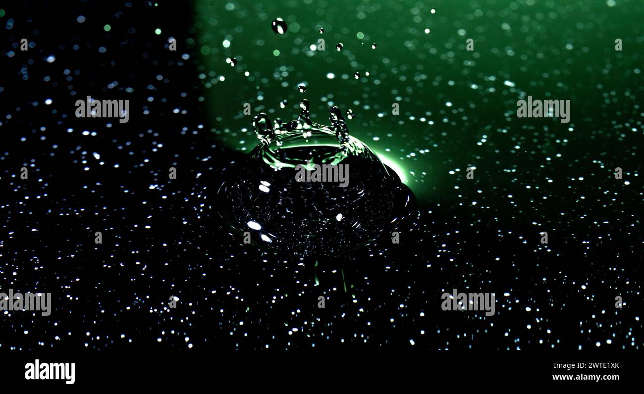 Splash - falling water drops in color macro shot Stock Photo - Alamy