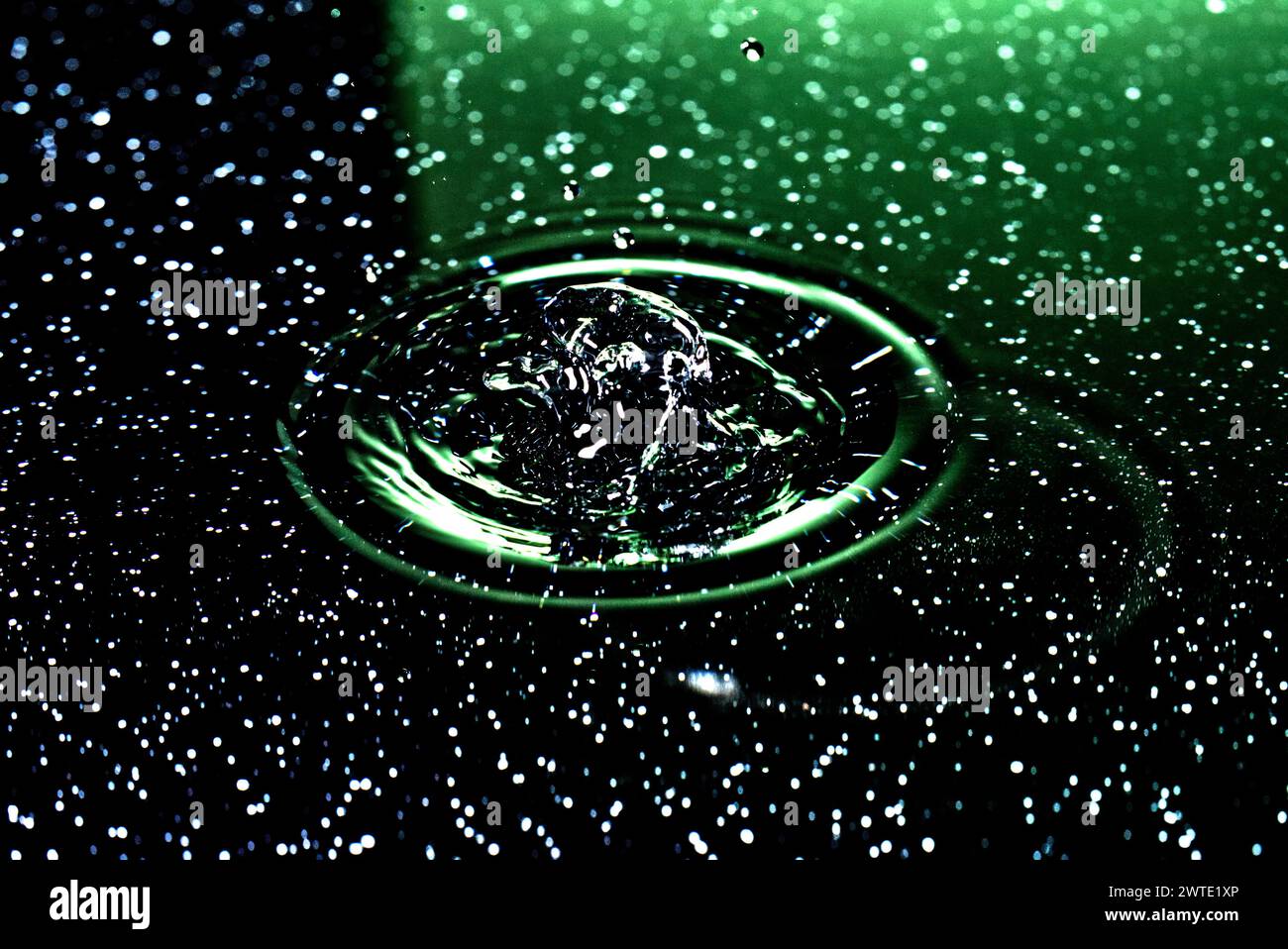 Splash - falling water drops in color macro shot Stock Photo - Alamy