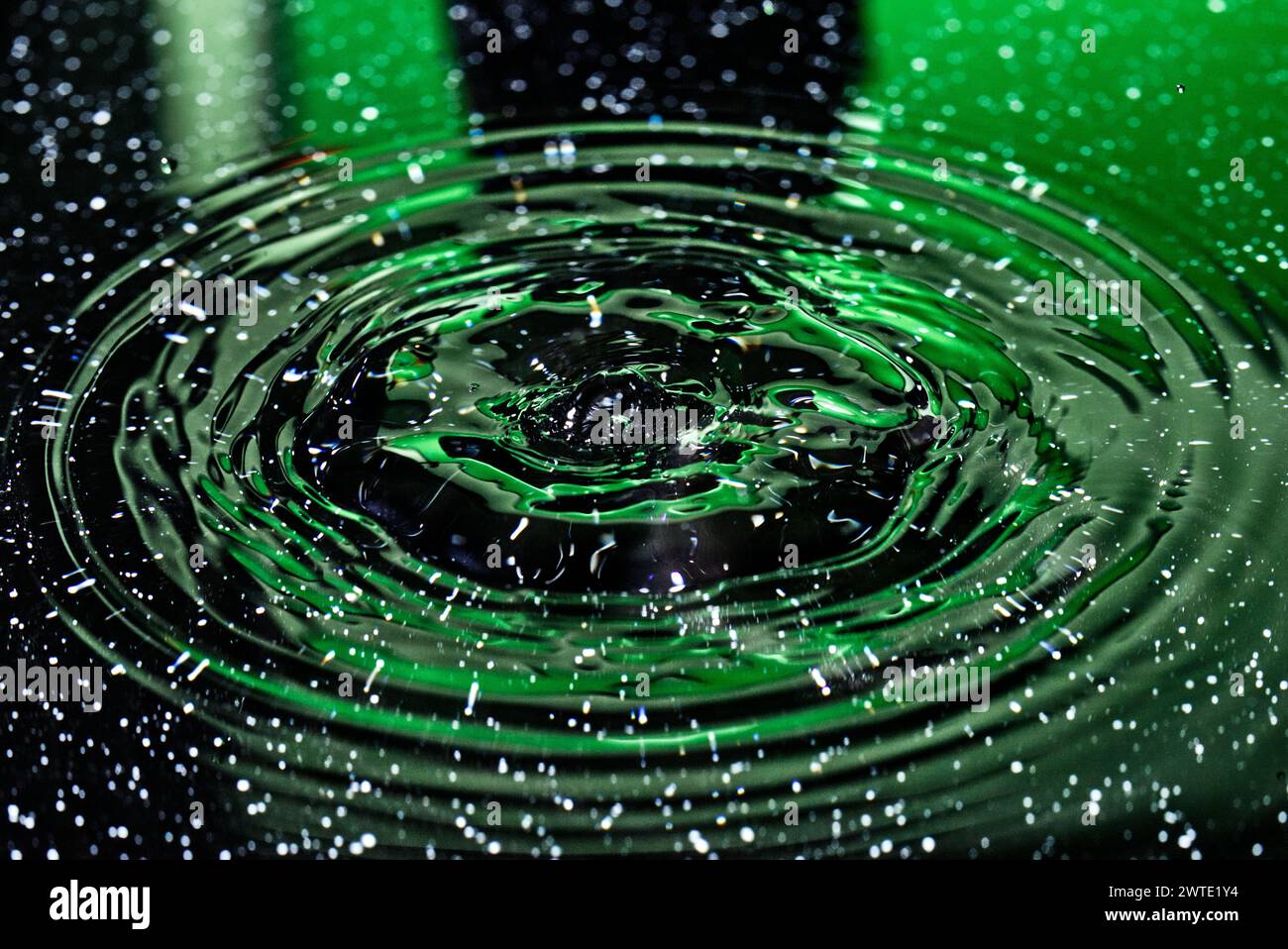 Splash - falling water drops in color macro shot Stock Photo - Alamy