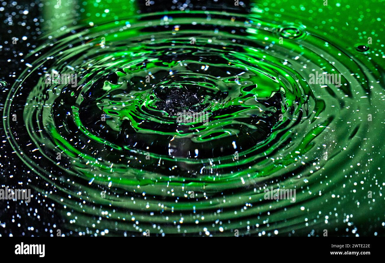 Splash - falling water drops in color macro shot Stock Photo - Alamy