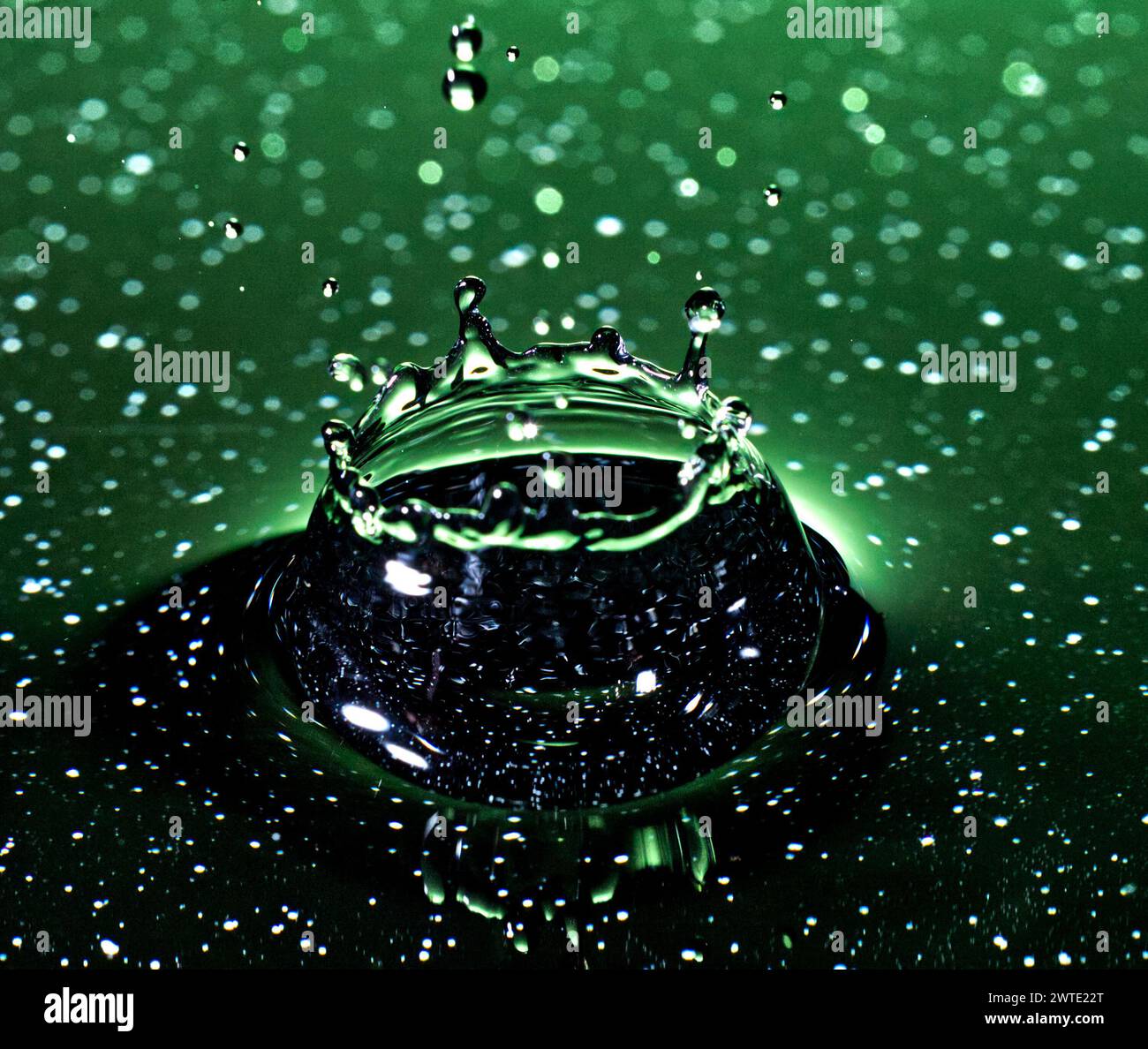 Splash - falling water drops in color macro shot Stock Photo - Alamy