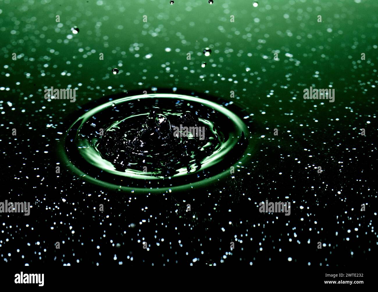 Splash - falling water drops in color macro shot Stock Photo - Alamy