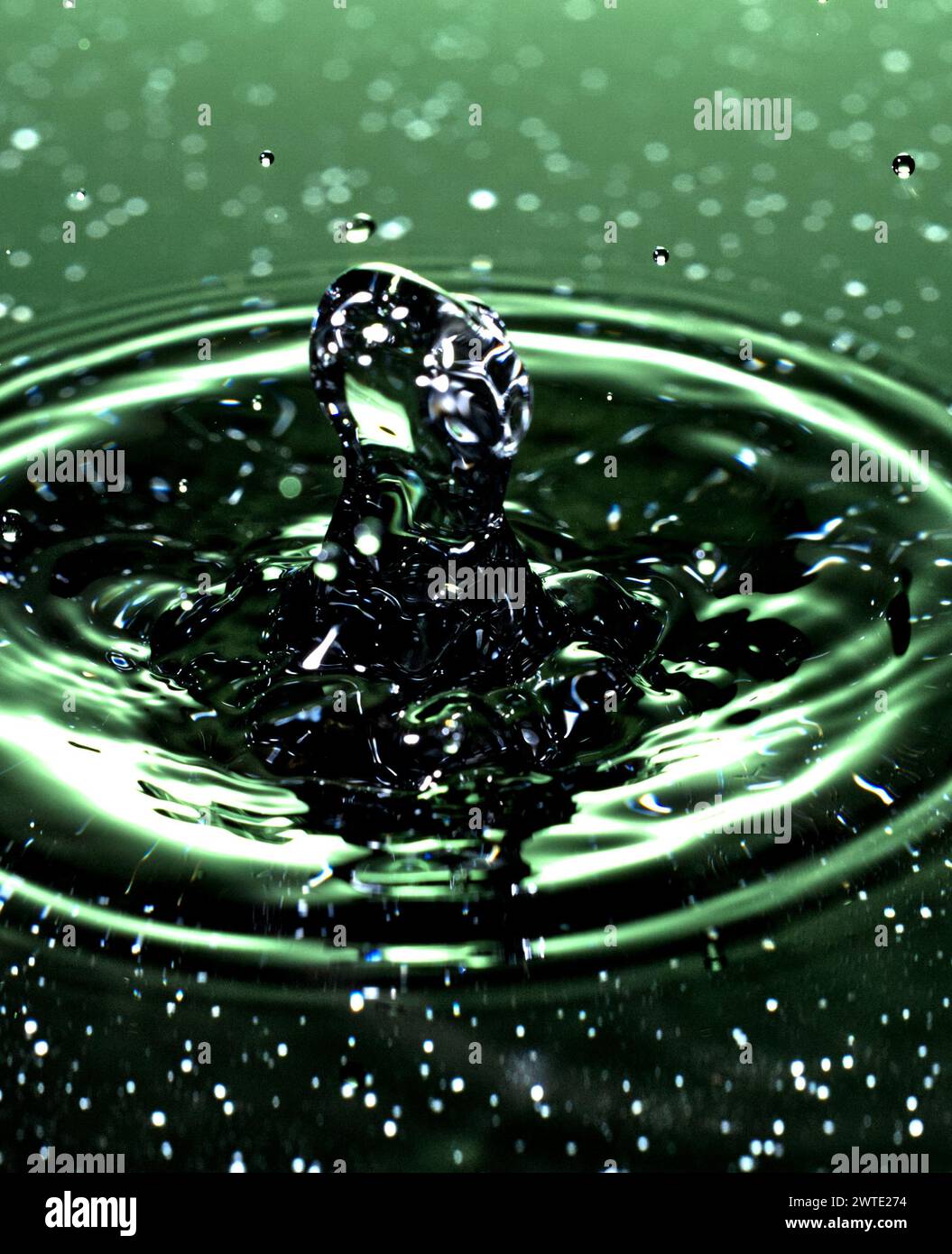 Splash - falling water drops in color macro shot Stock Photo - Alamy