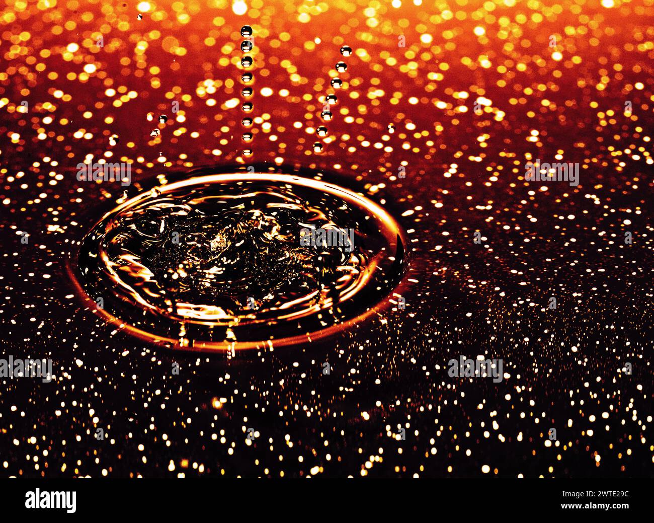 Splash - falling water drops in color macro shot Stock Photo - Alamy