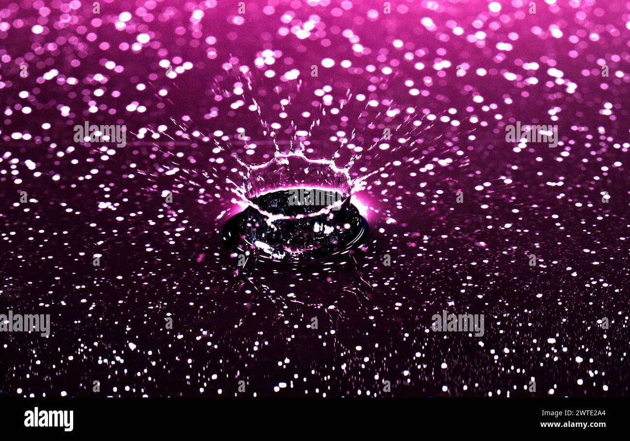 Splash - falling water drops in color macro shot Stock Photo - Alamy