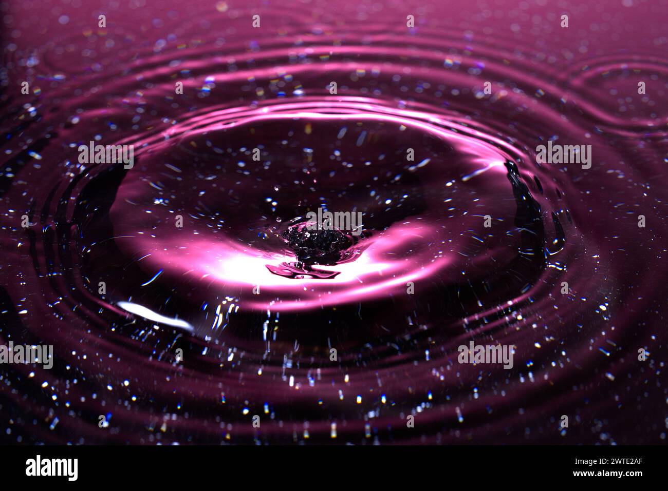 Splash - falling water drops in color macro shot Stock Photo - Alamy