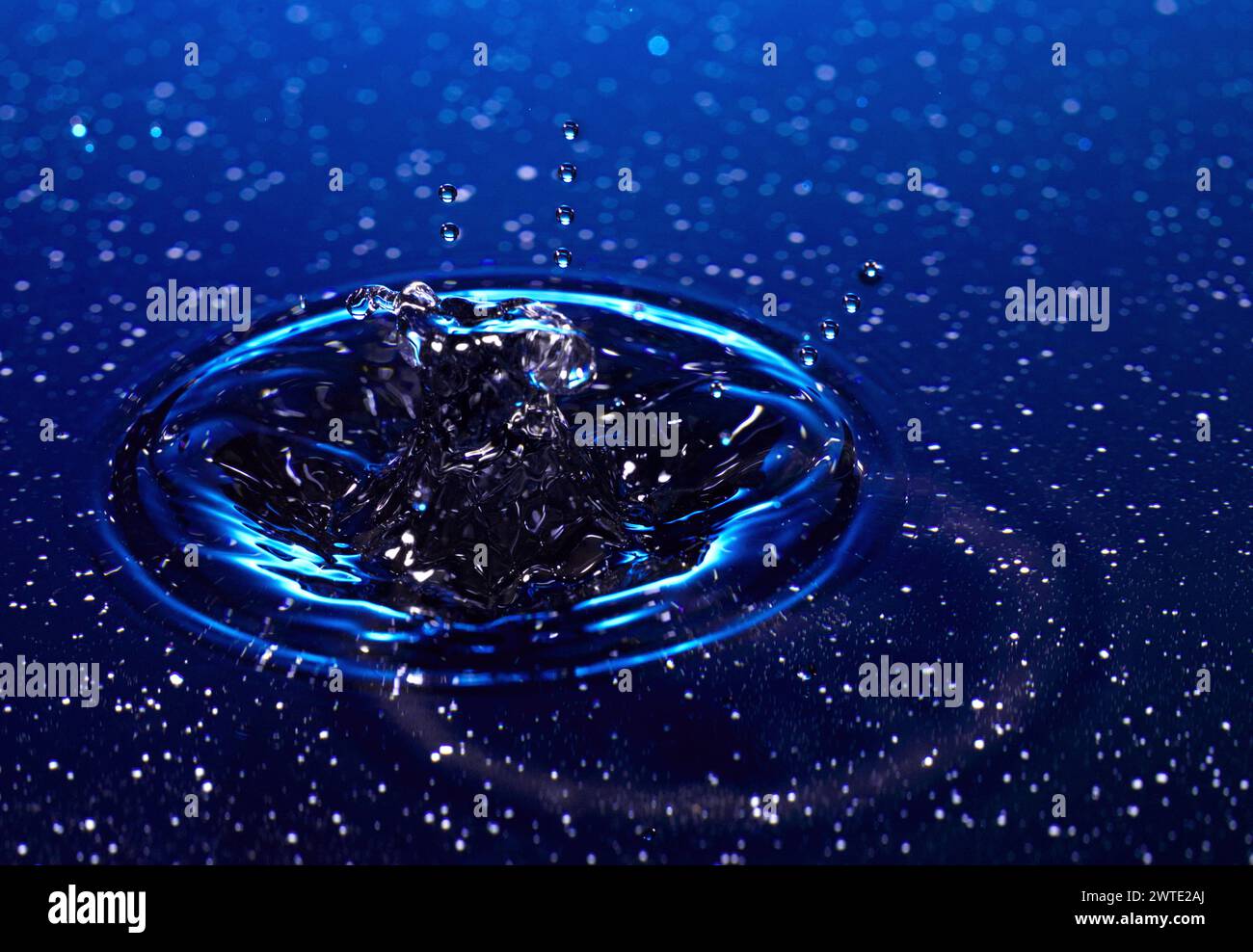 Splash - falling water drops in color macro shot Stock Photo - Alamy