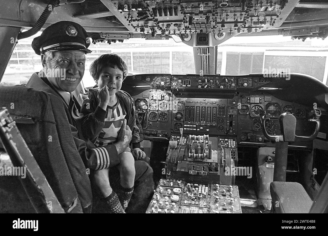1970s, historical, young boy sitting in a cockpit with a pilot Stock ...