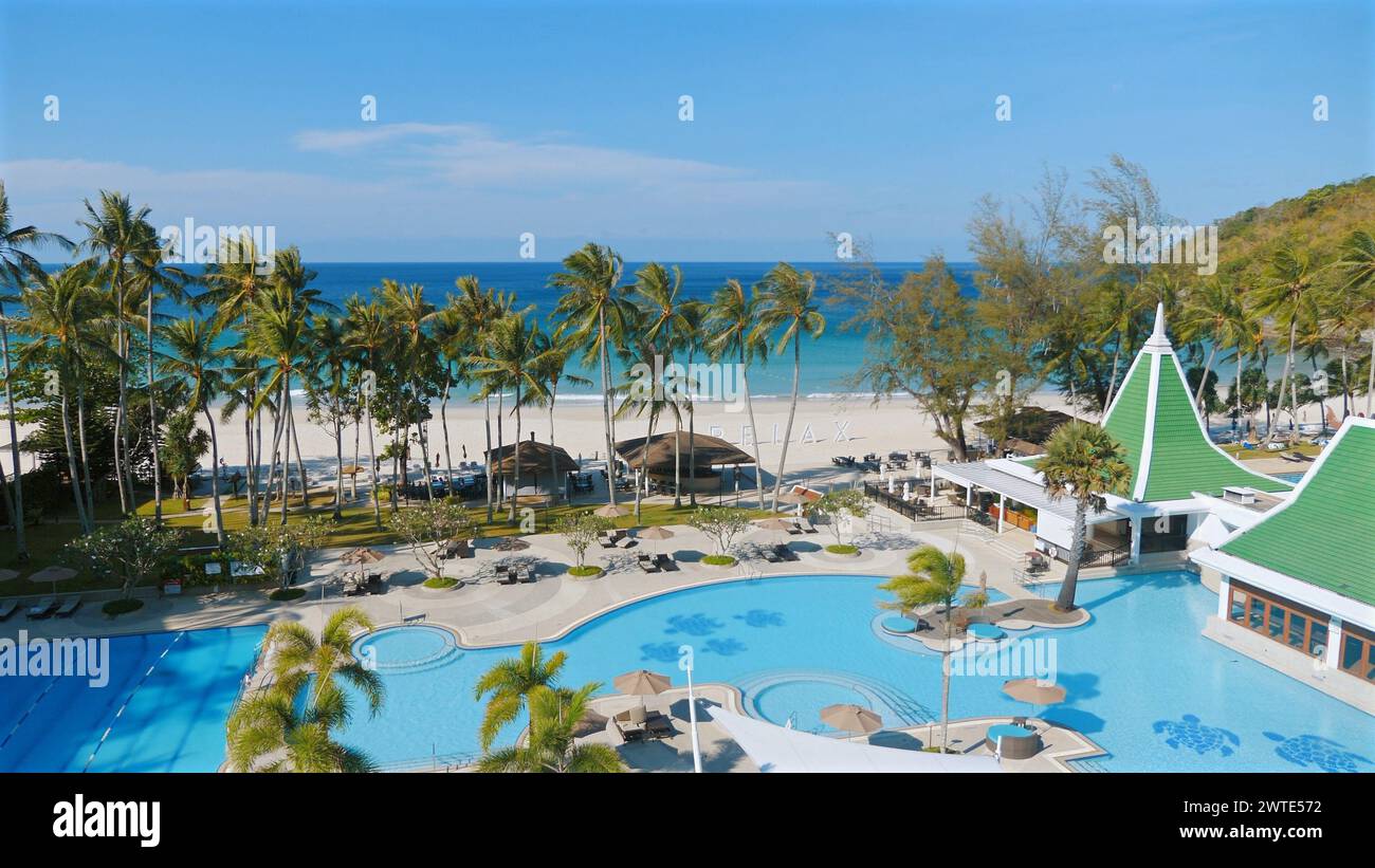 Tropical beach resort panoramic view with palm trees, swimming pools ...