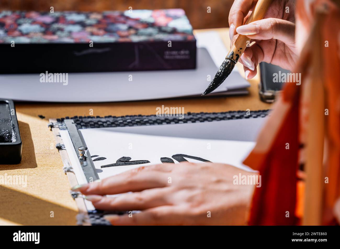 Hand holding traditional writing brush hi-res stock photography and ...