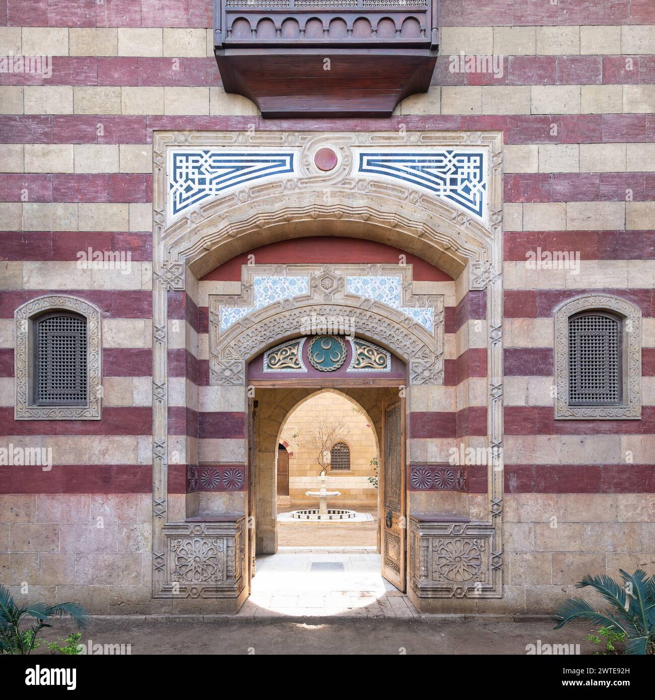 Striking red and white striped arched entrance leads into a Mamluk era ...