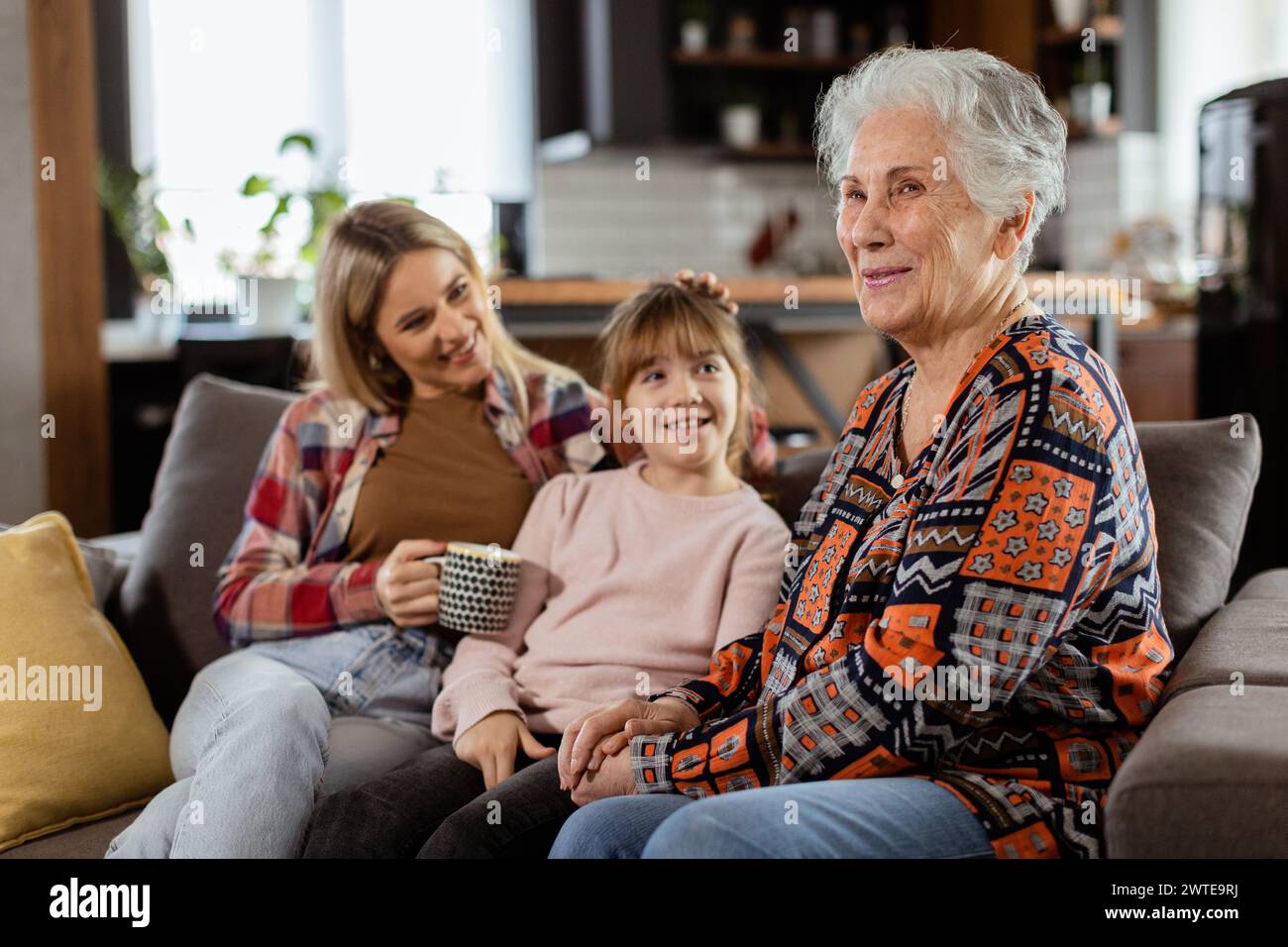 Three generations of women enjoy laughter and conversation on a ...