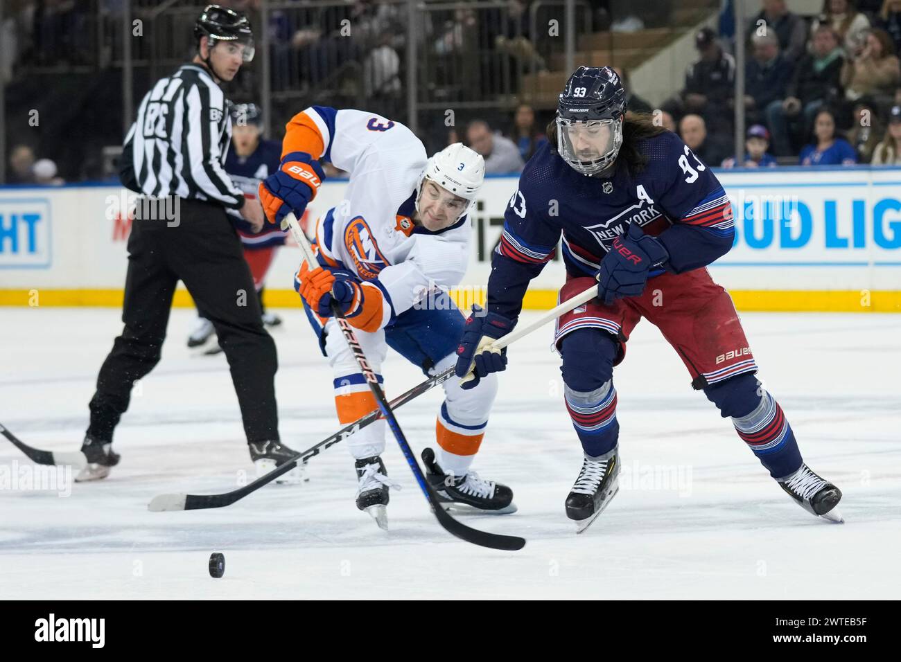 New York Islanders' Adam Pelech, left, and New York Rangers' Mika ...