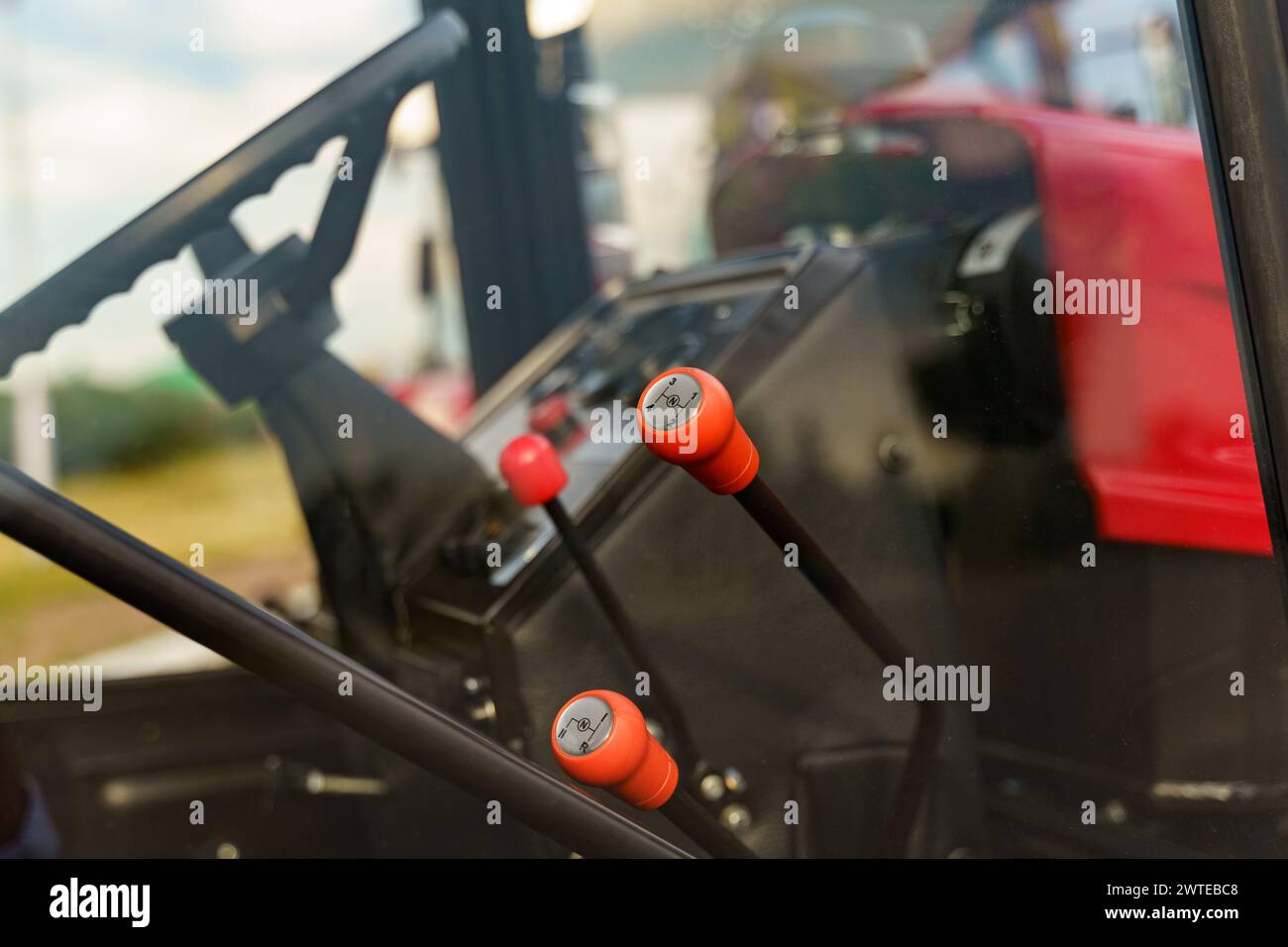 A close-up view highlighting the control levers inside the cabin of a ...