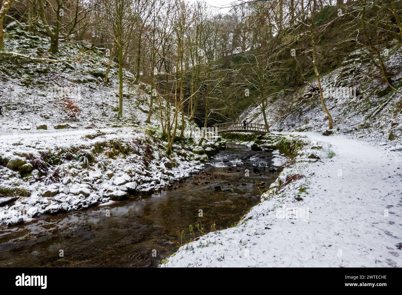 The wooden arched bridge over Hardraw Beck on a snowy morning in ...