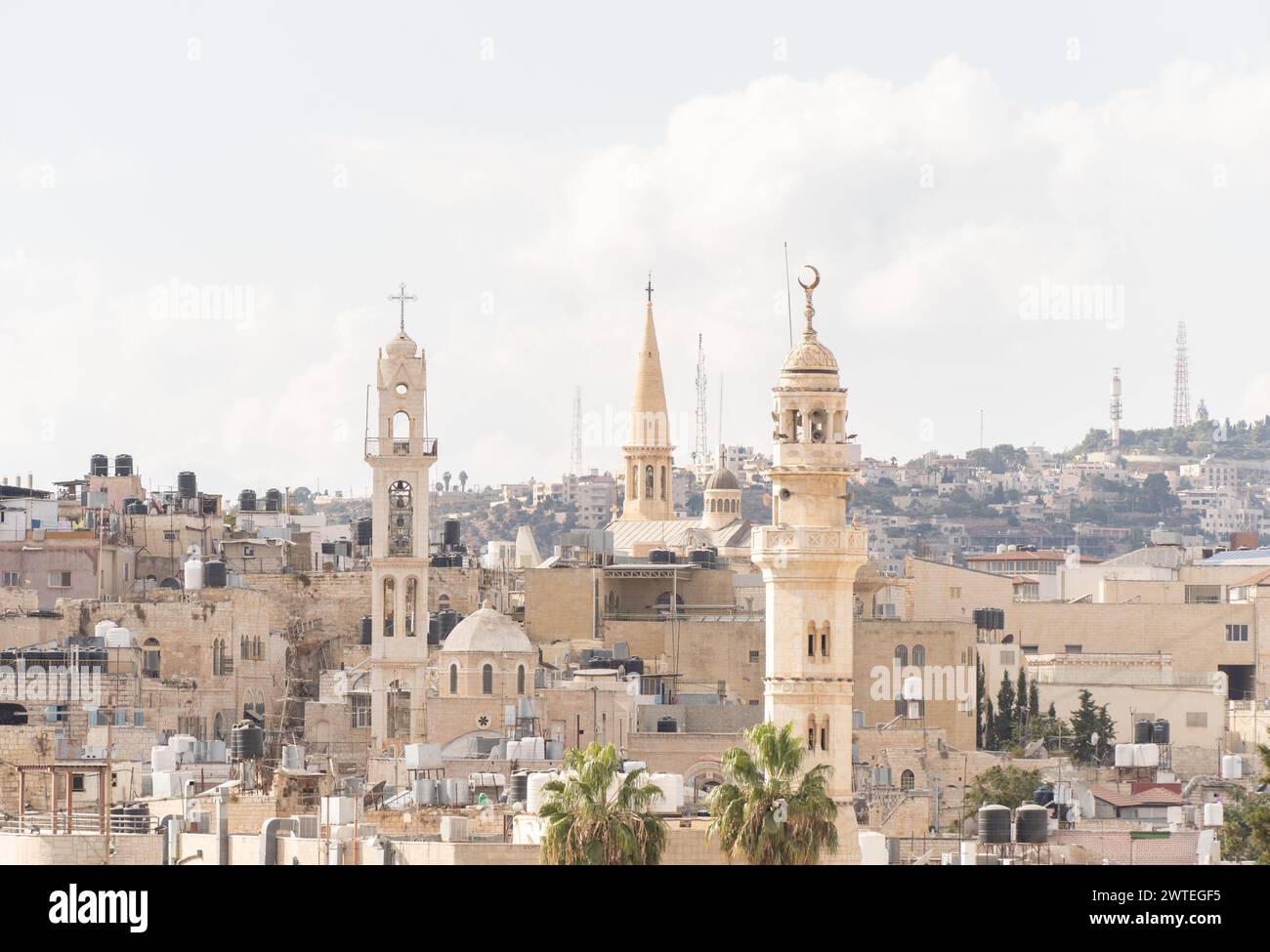 A panoramic cityscape featuring a central clock tower amidst tall ...