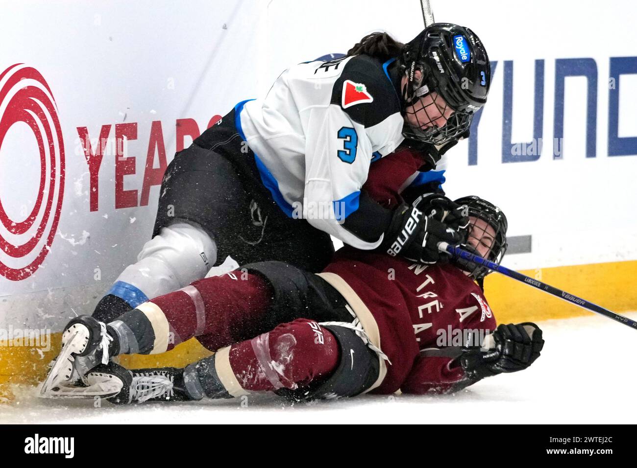 Toronto's Jocelyne Larocque (3) slides into the boards with Montreal's ...