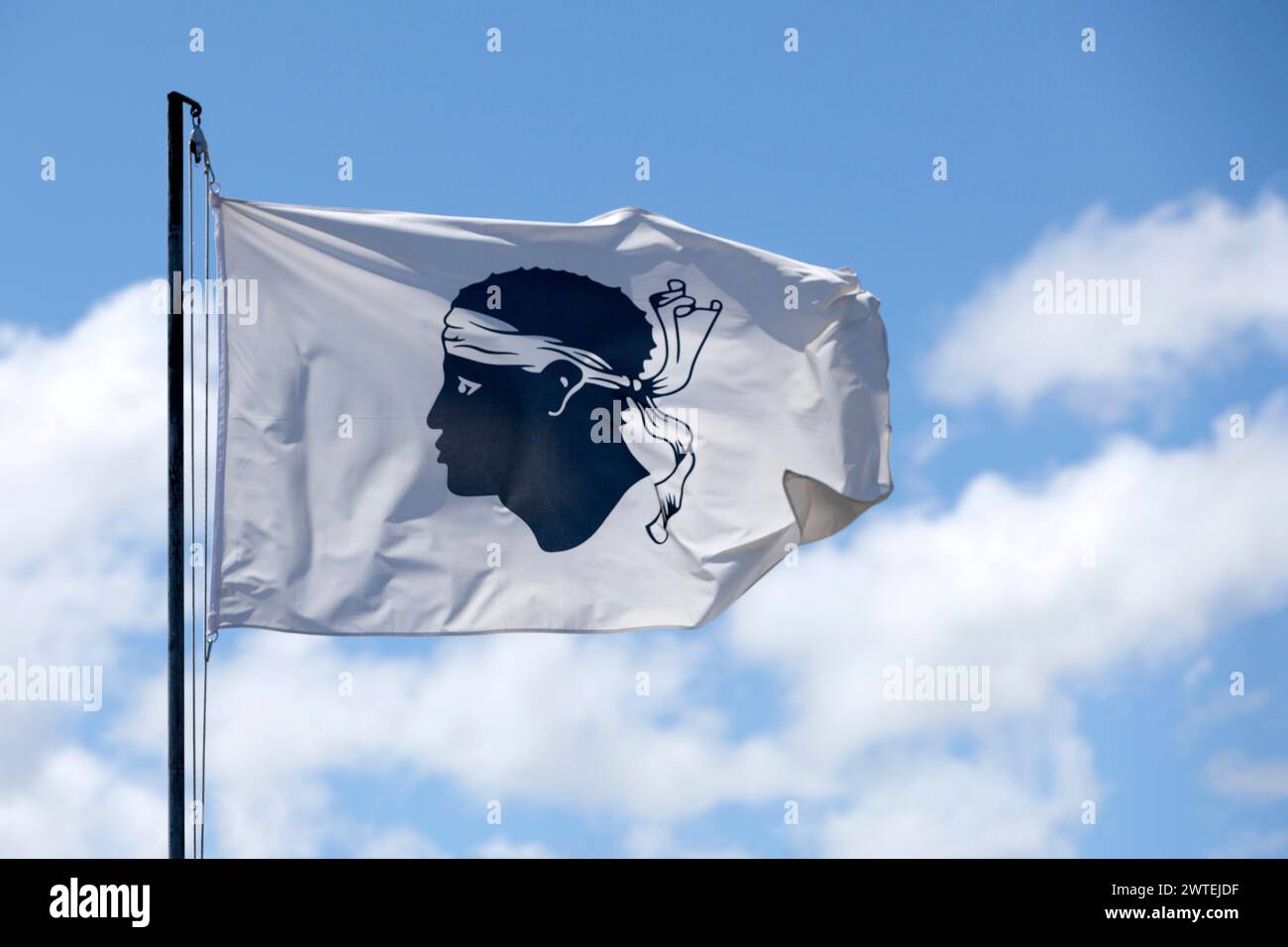 Flag of Corsica waving atop of its pole Stock Photo - Alamy
