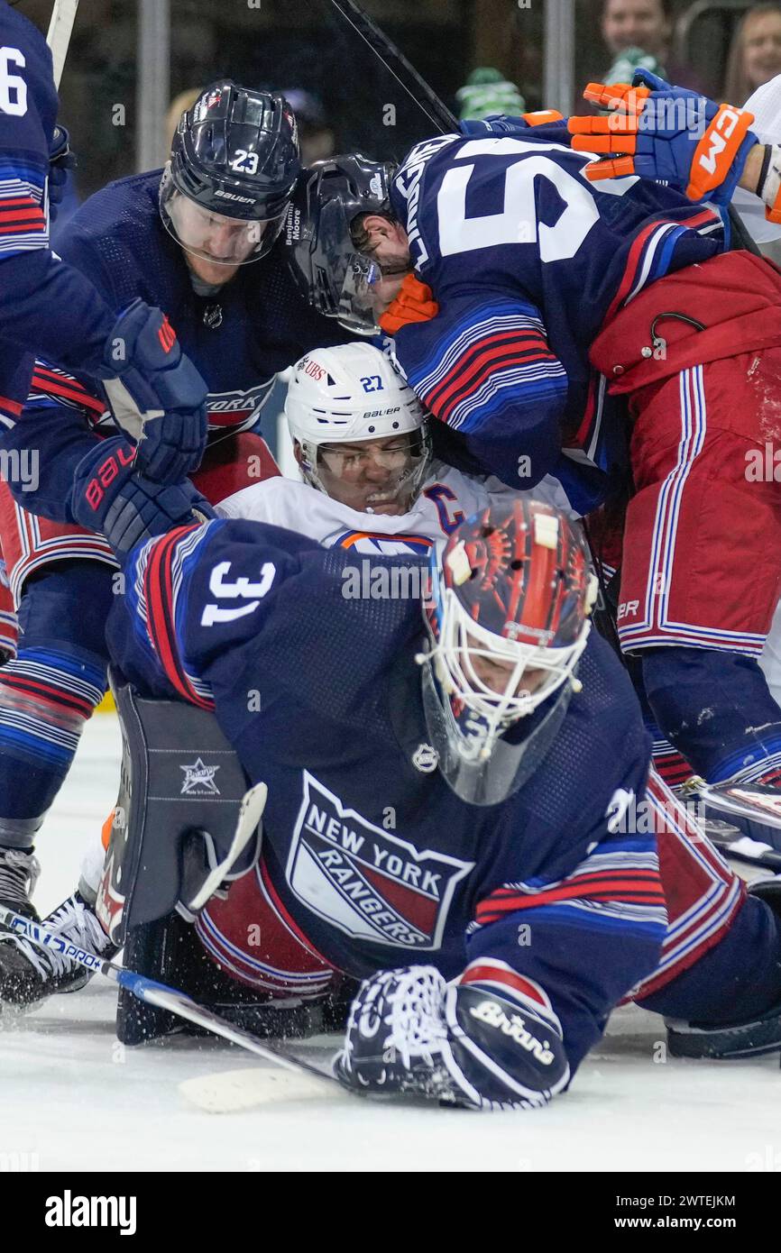 New York Rangers goaltender Igor Shesterkin, bottom, tries to get out ...