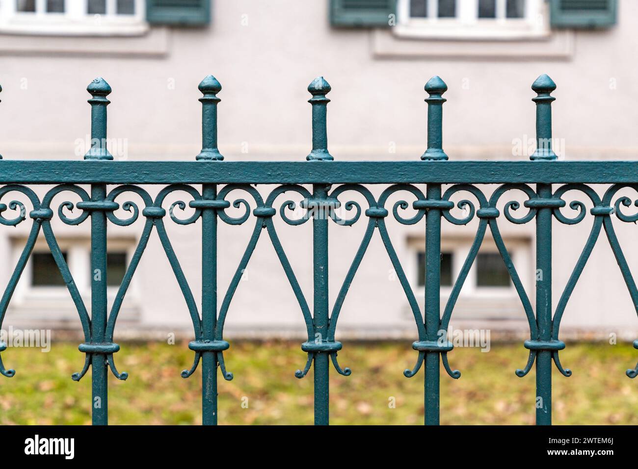 Green painted wrought iron fences close up, detail from vintage style ...
